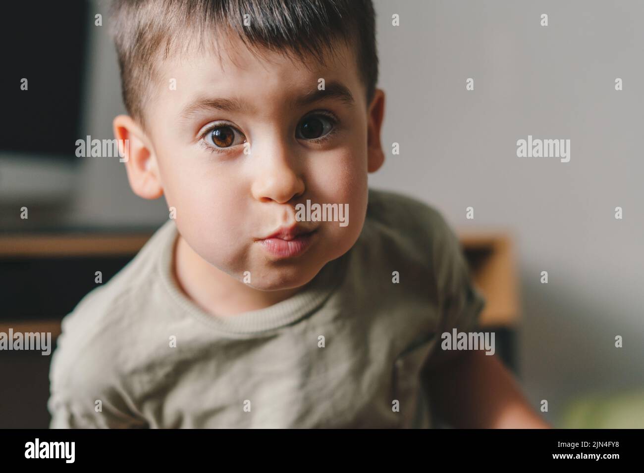 Little caucasian boy smiling at the camera with mouth full of food ...