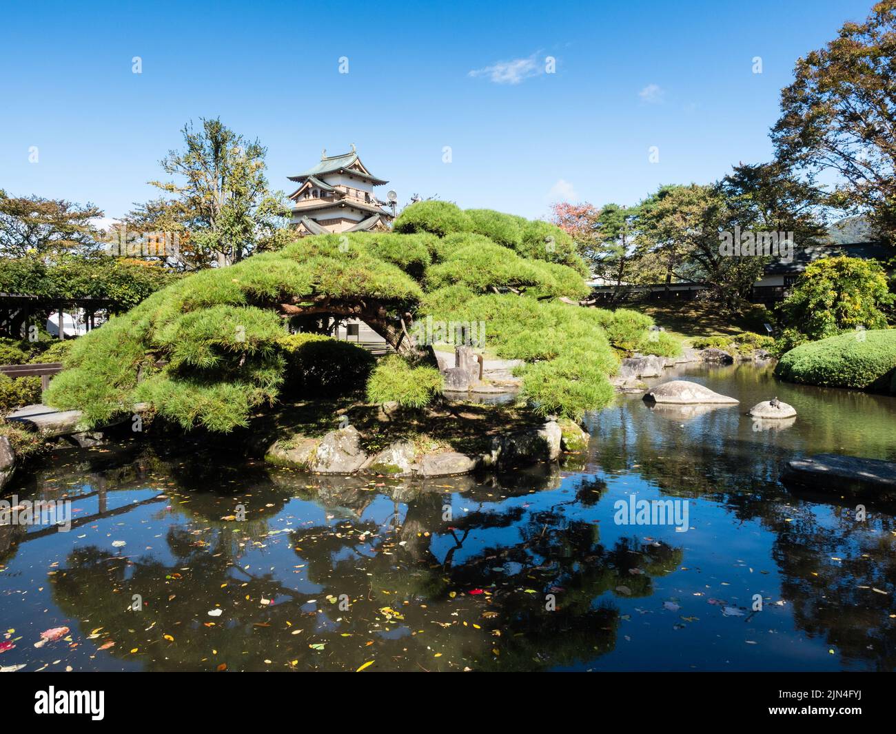 Traditional Japanese public garden with pond near reconstructed ...