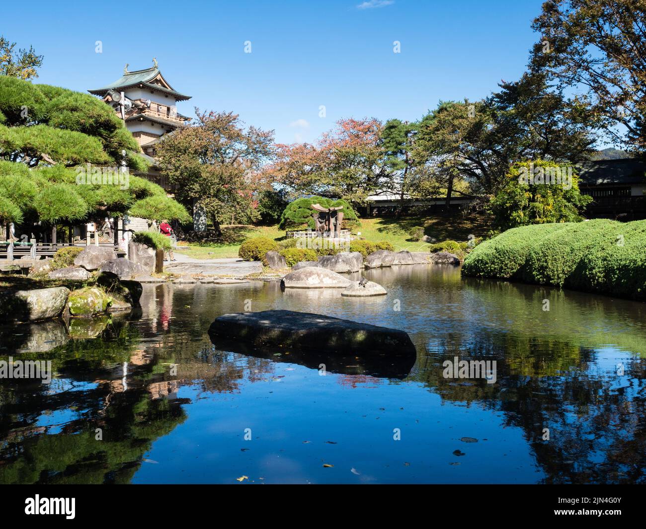 Traditional Japanese public garden with pond near reconstructed ...