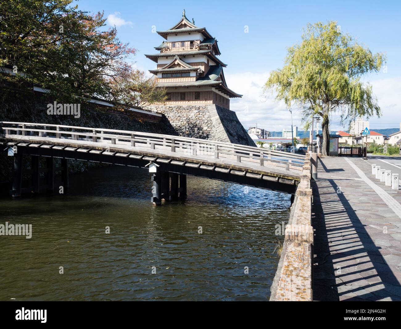 Wooden bridge across the moat leading to historic Takashima castle in ...