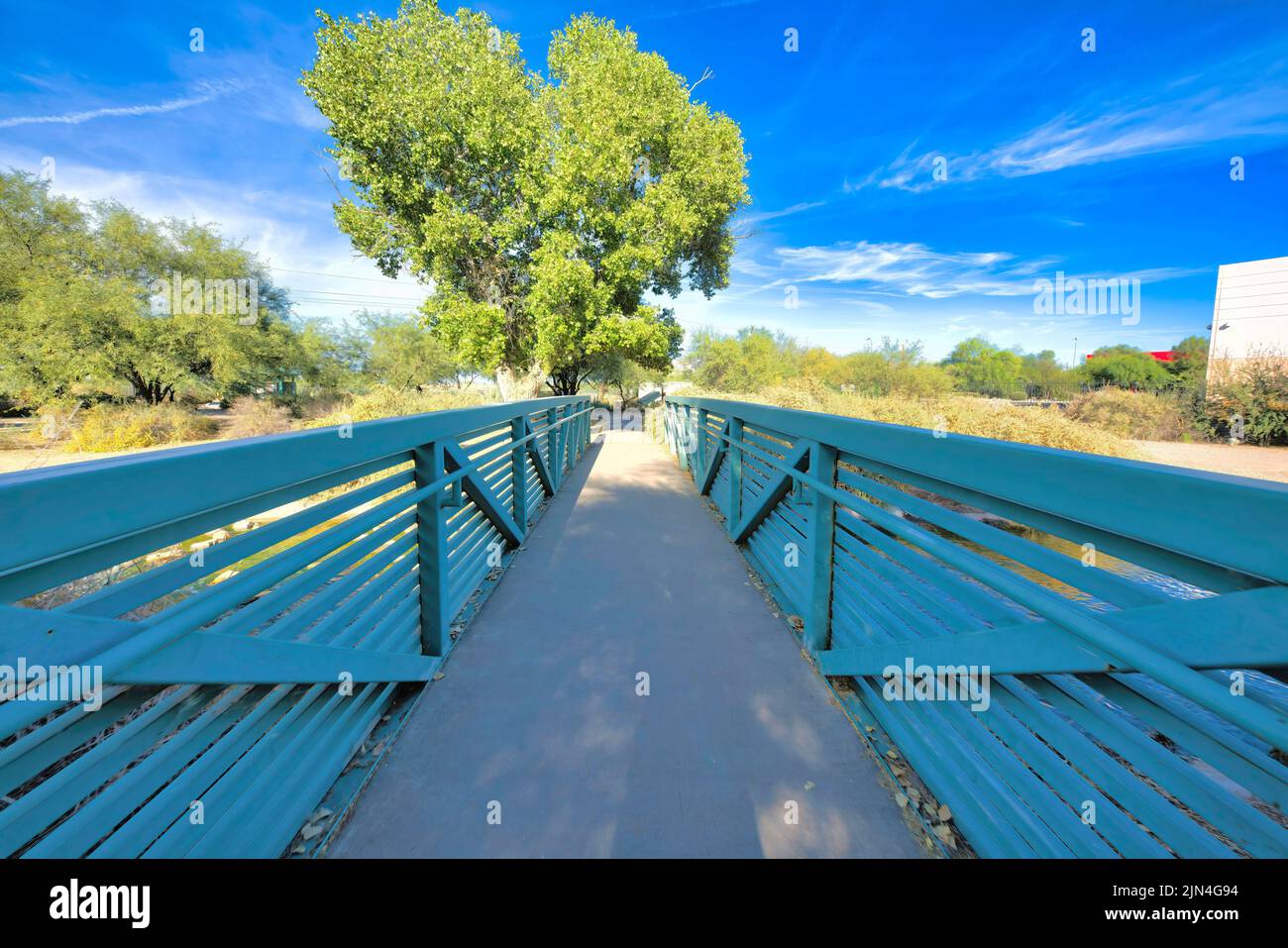 Bridge with concrete pathway and metal railings at Sweetwater Wetlands ...