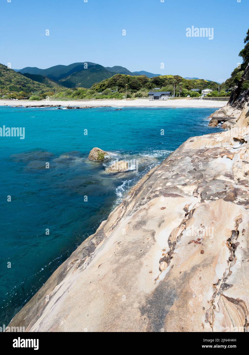 Sandstone rock formations and clear blue waters at Tatsukushi coast - a ...