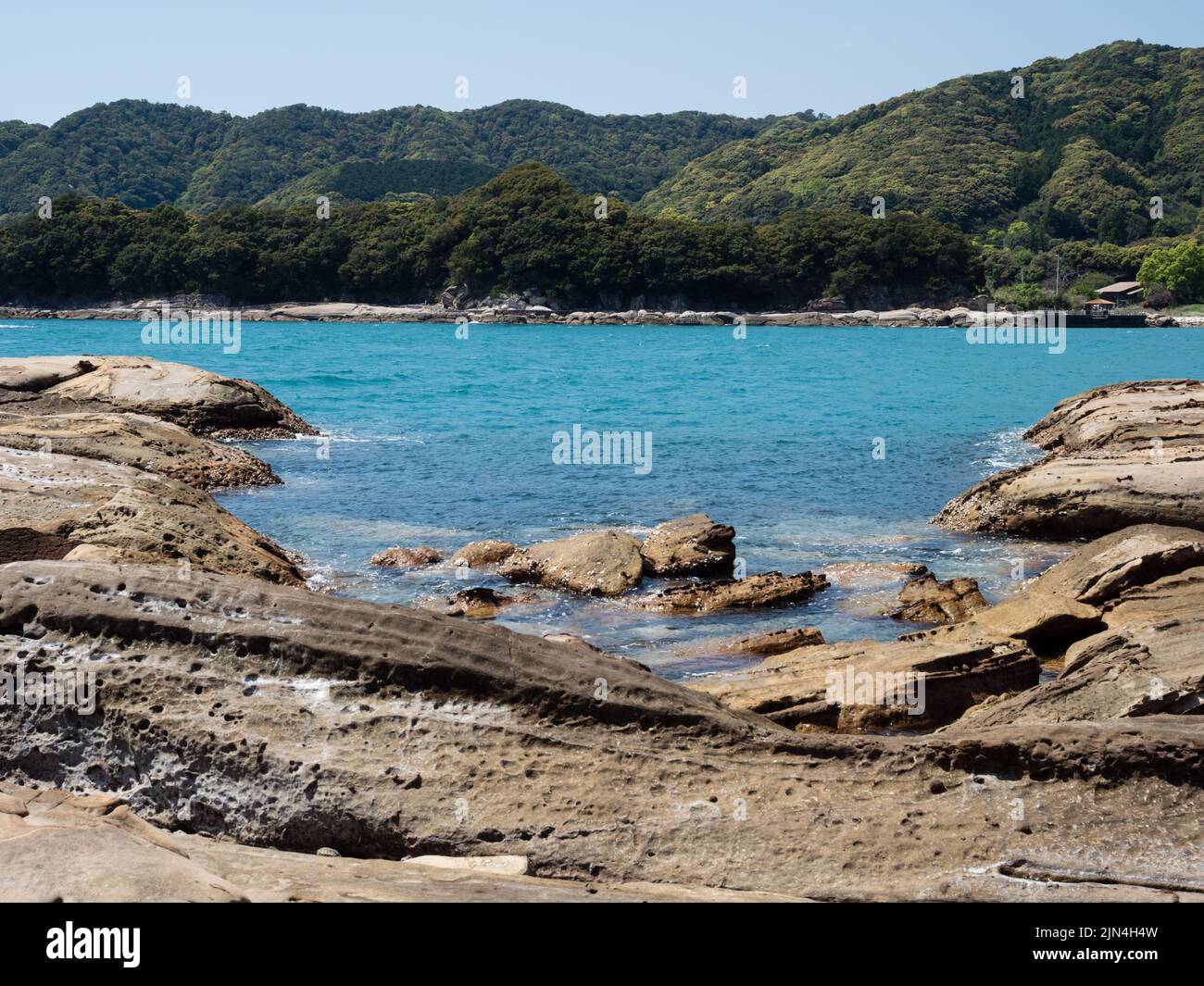 Sandstone rock formations and clear blue waters at Tatsukushi coast - a ...
