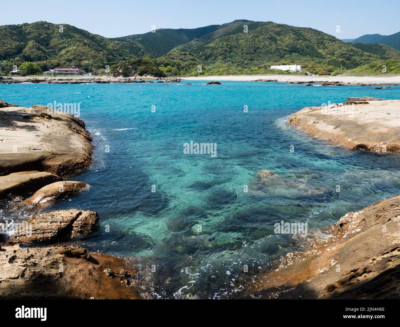 Sandstone rock formations and clear blue waters at Tatsukushi coast - a ...