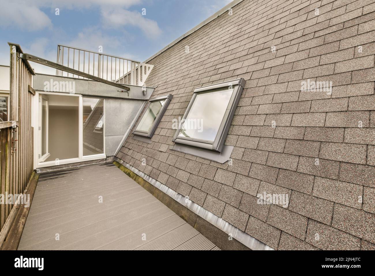 Bright brick balcony with metal railings and door Stock Photo - Alamy