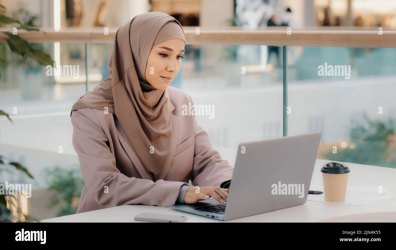 Focused serious arab businesswoman professional entrepreneur sitting at ...