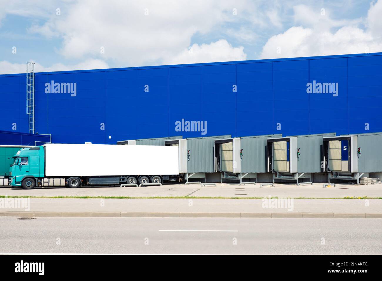 Truck near loading dock of warehouse outdoors. Warehouse area of big ...