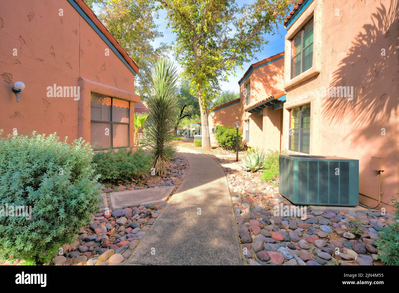 Narrow curved concrete path in the middle of italianate houses in ...
