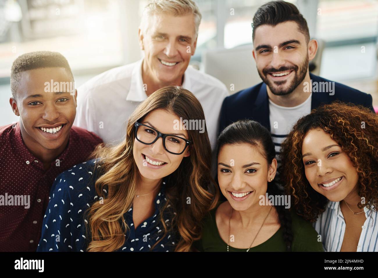 Diverse group of smiling creative designers looking confident, happy and cheerful after a ...