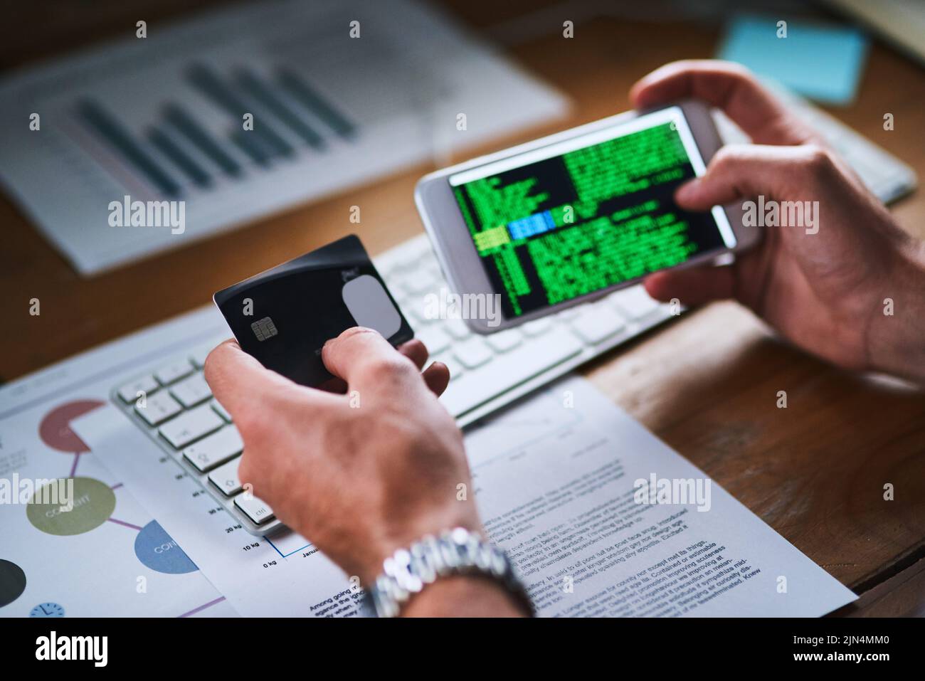 Cybersecurity issues or credit card theft by a hacker using his phone ...