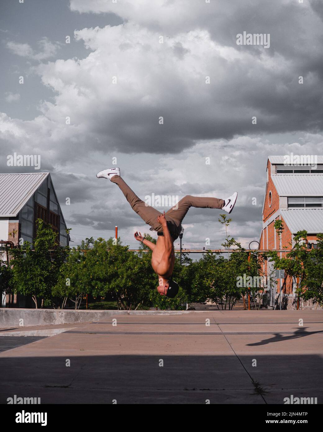 Young man performing somersault hi-res stock photography and images - Alamy