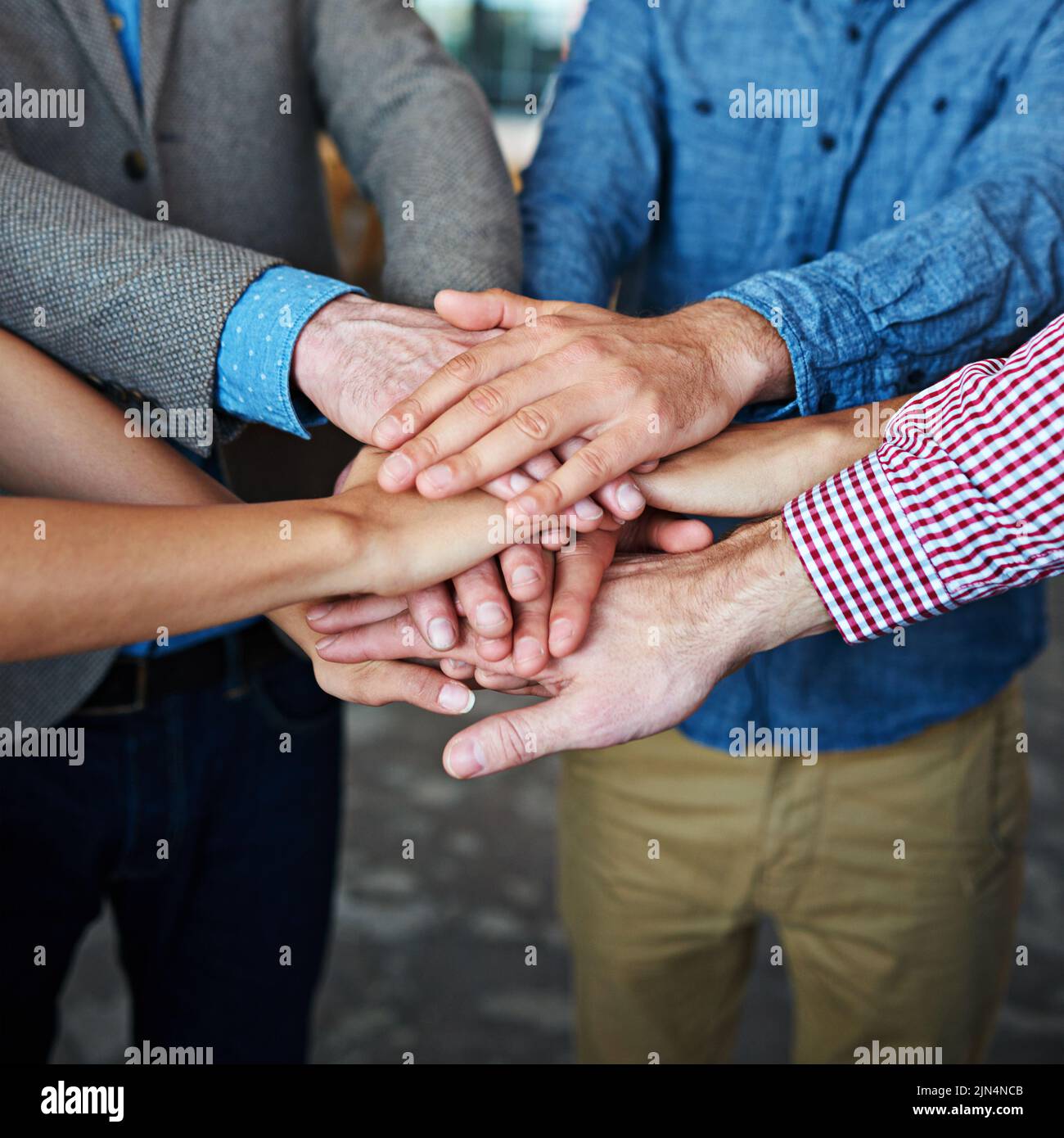 Teamwork, collaboration and support while putting hands together in an ...