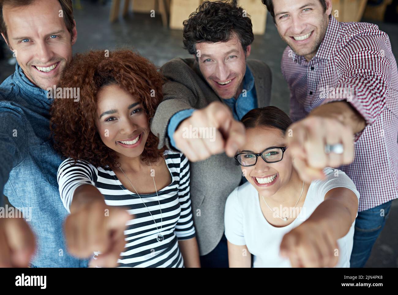 Happy, fun and smiling group of office colleagues pointing and looking ...