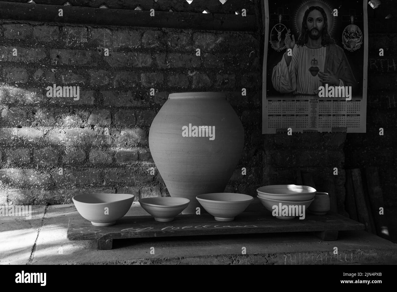 A closeup of clay jugs near calendar with Jesus photo Stock Photo - Alamy
