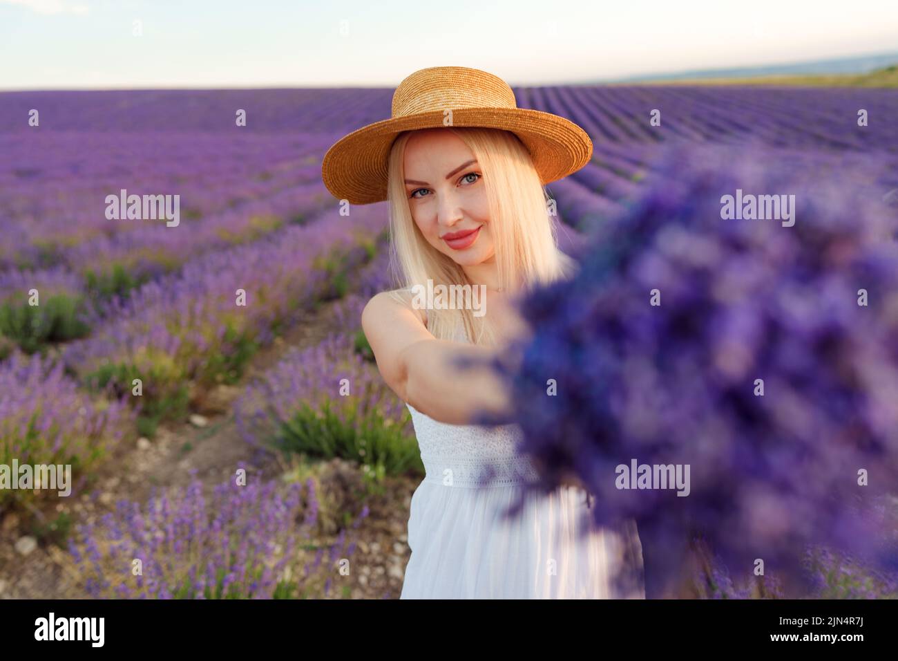 Blond haired girl standing in lavender field Stock Photo - Alamy