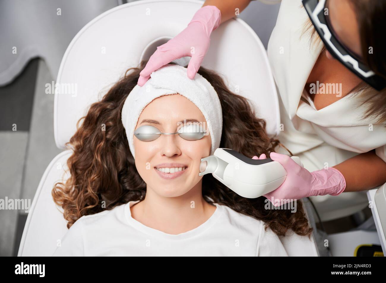 Close-up view laser correction process of vascular asterisks on face in ...