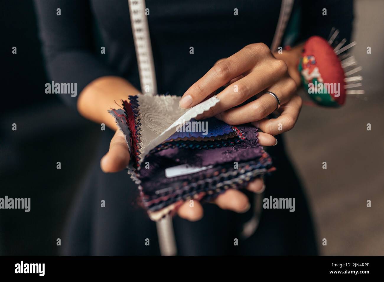 Close up of female hands holding fabric swatches. Focus on female hands ...
