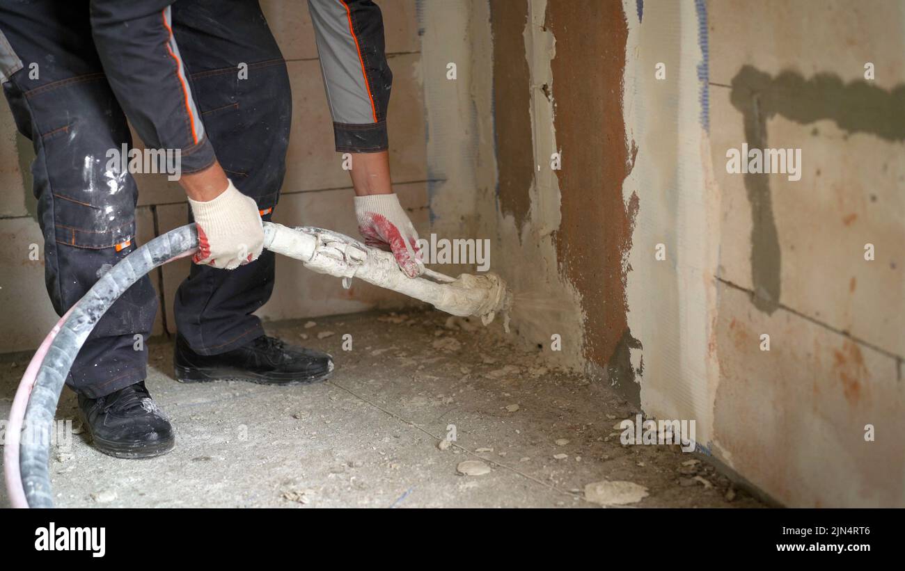 Application of plaster in a mechanized way. The plaster is applied with ...