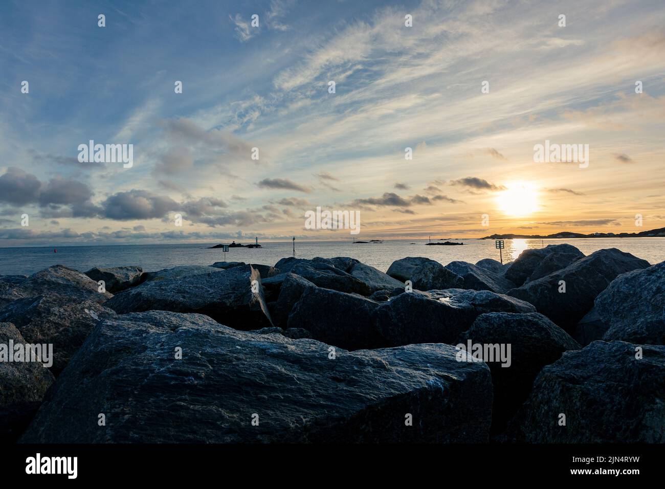 The seascape from the rocky shore with little islands under the blue ...