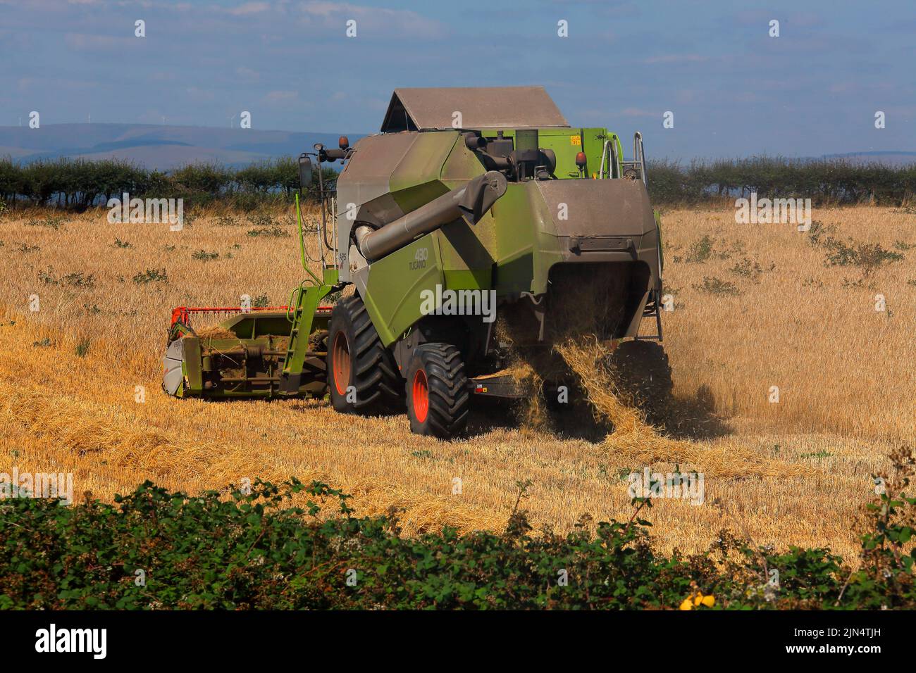 The local farmer out in his Combine Harvester gathering in this years ...
