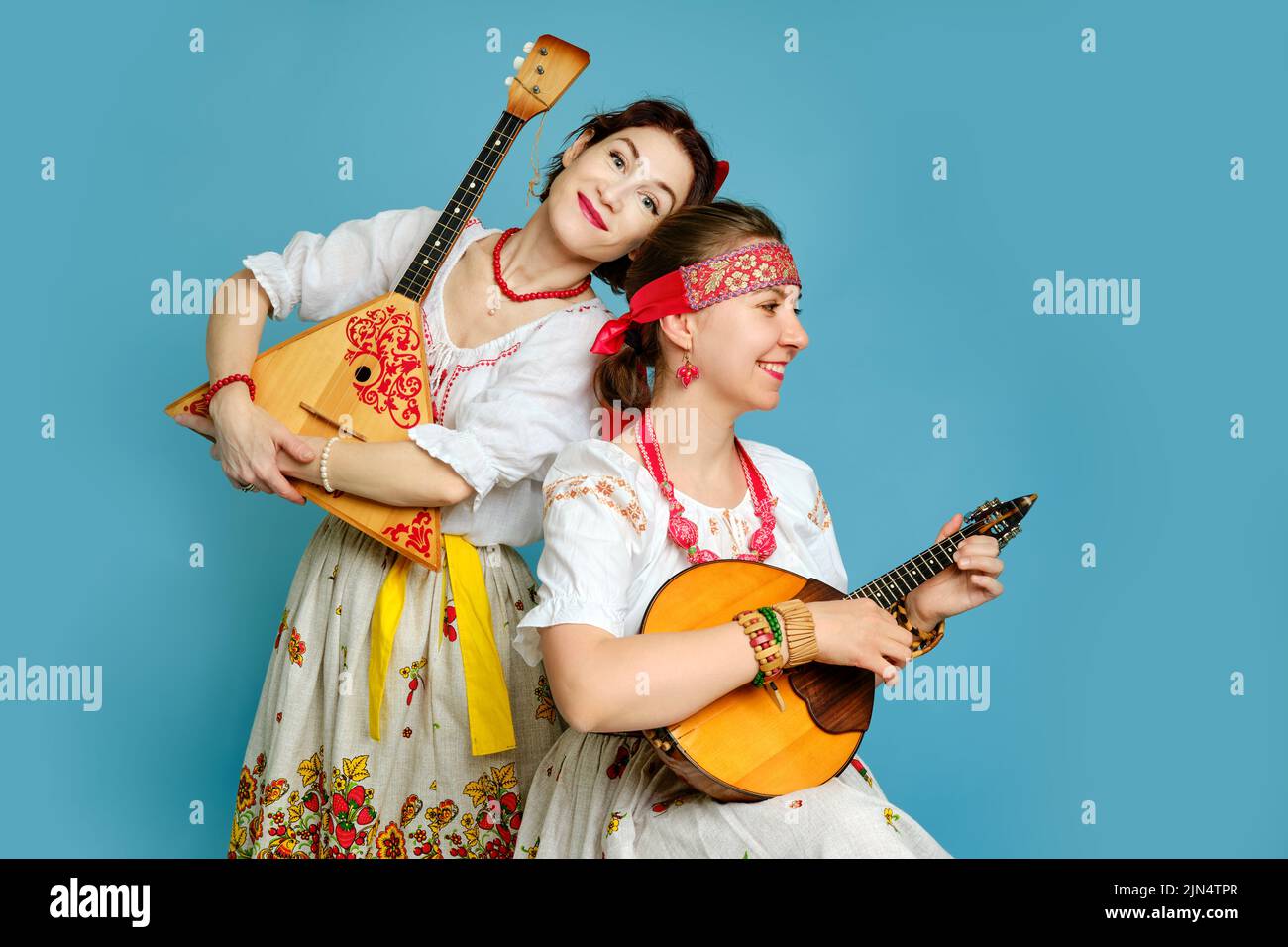 Women musicians in Russian folk dresses with musical instruments on a ...