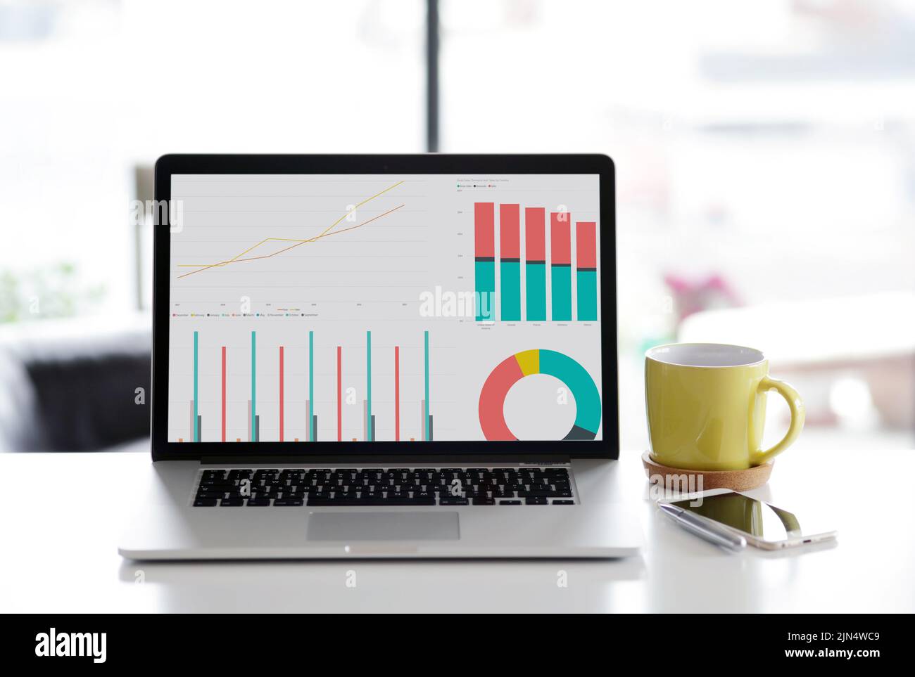 Home office setup showing a laptop screen with trending data Stock ...