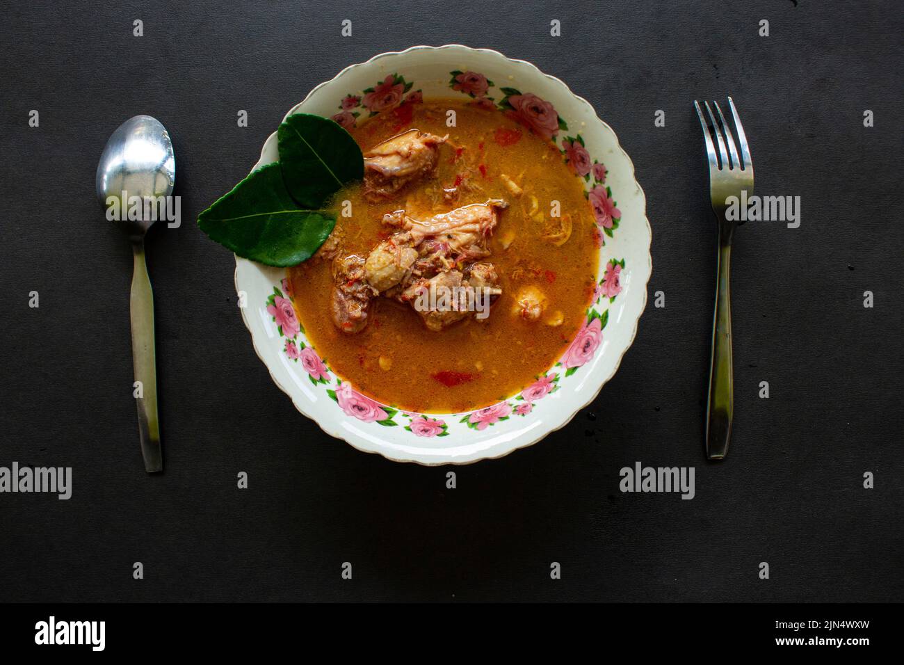 chicken curry or kari ayam served on bowl, isolated on white background ...