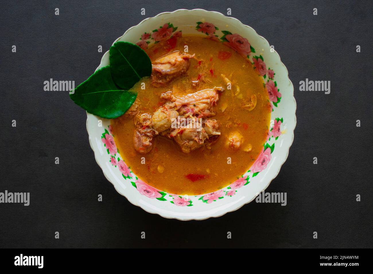 chicken curry or kari ayam served on bowl, isolated on white background ...