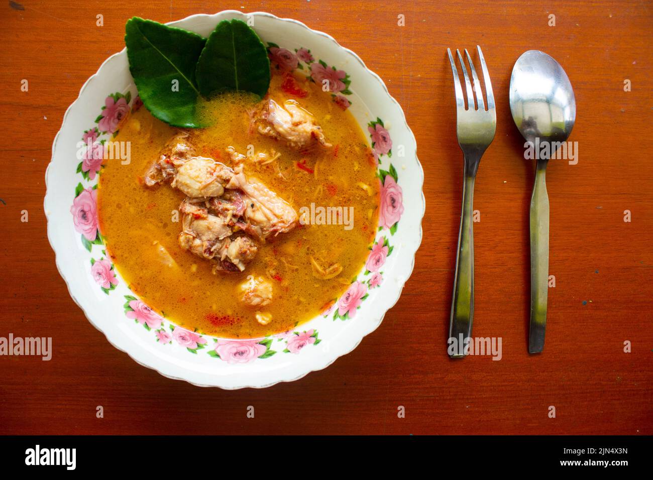 chicken curry or kari ayam served on bowl, isolated on white background ...