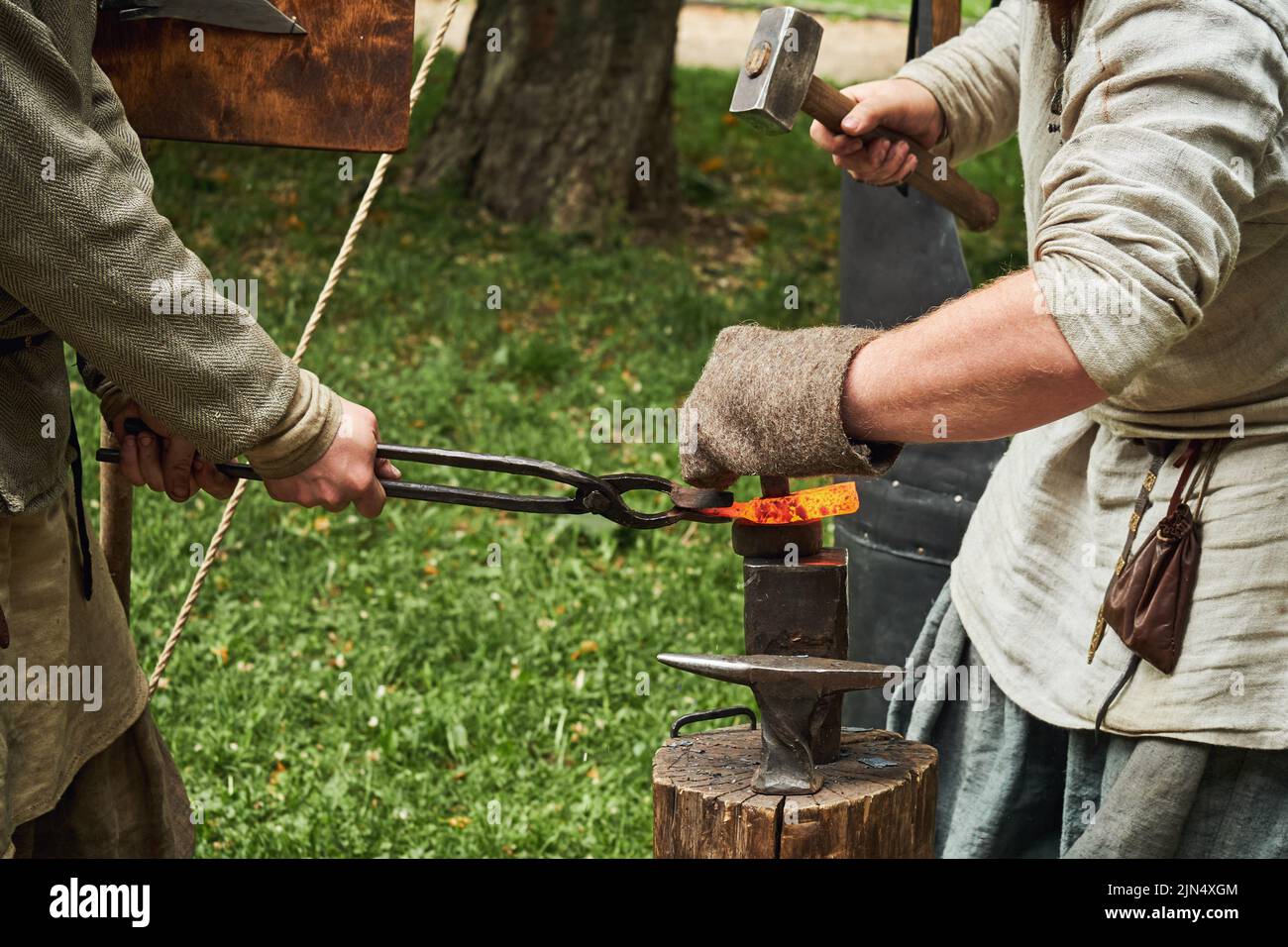 Work of a medieval blacksmith for the manufacture of metal products ...