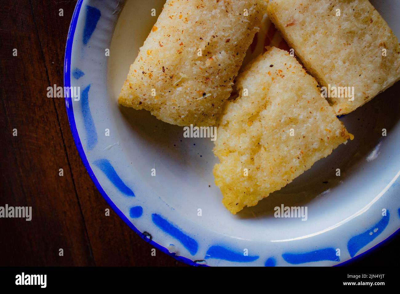jadah goreng or Fried sticky rice cake served enamel plate. on wood ...