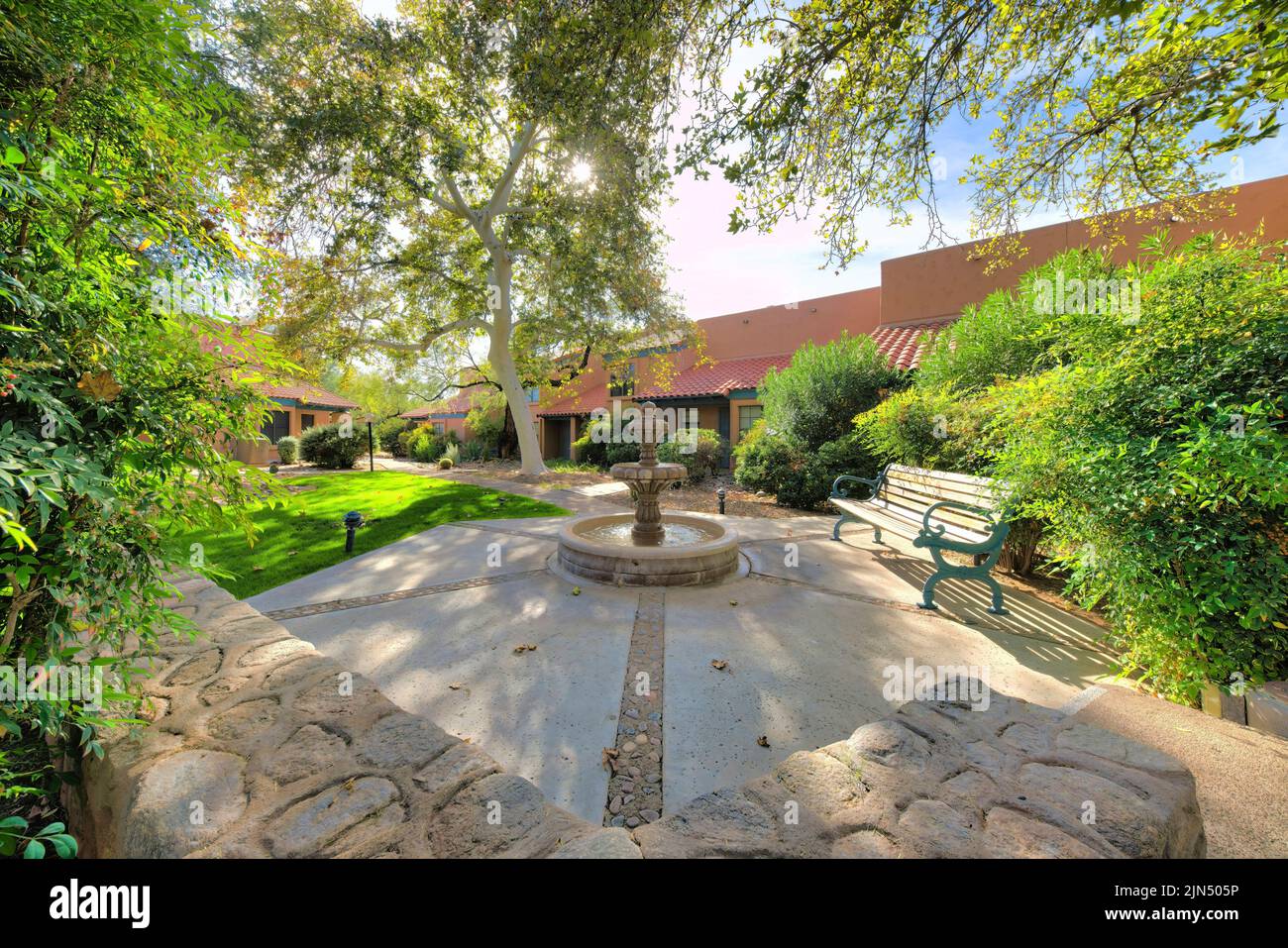Water fountain and bench surrounded by the italianate houses in a ...