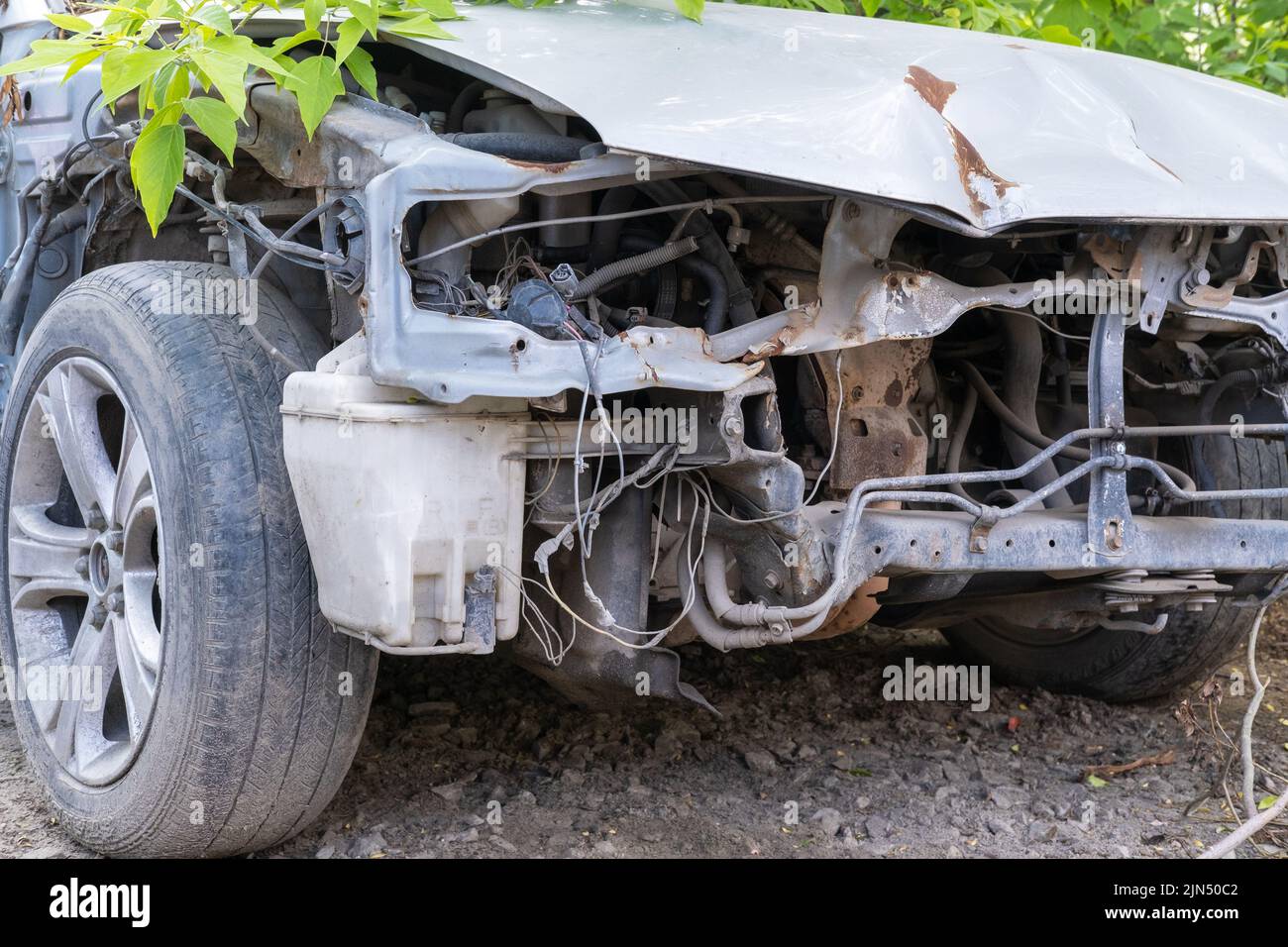 The broken body of an old rusty car with an electric drive, without a ...