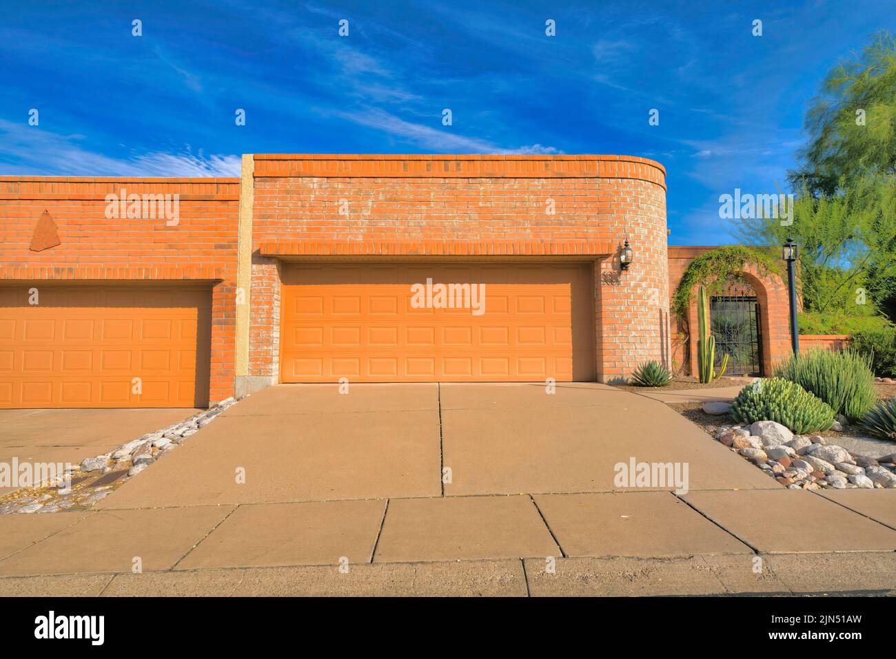 Two garage doors with wall bricks at Tucson, Arizona. Garage exterior ...