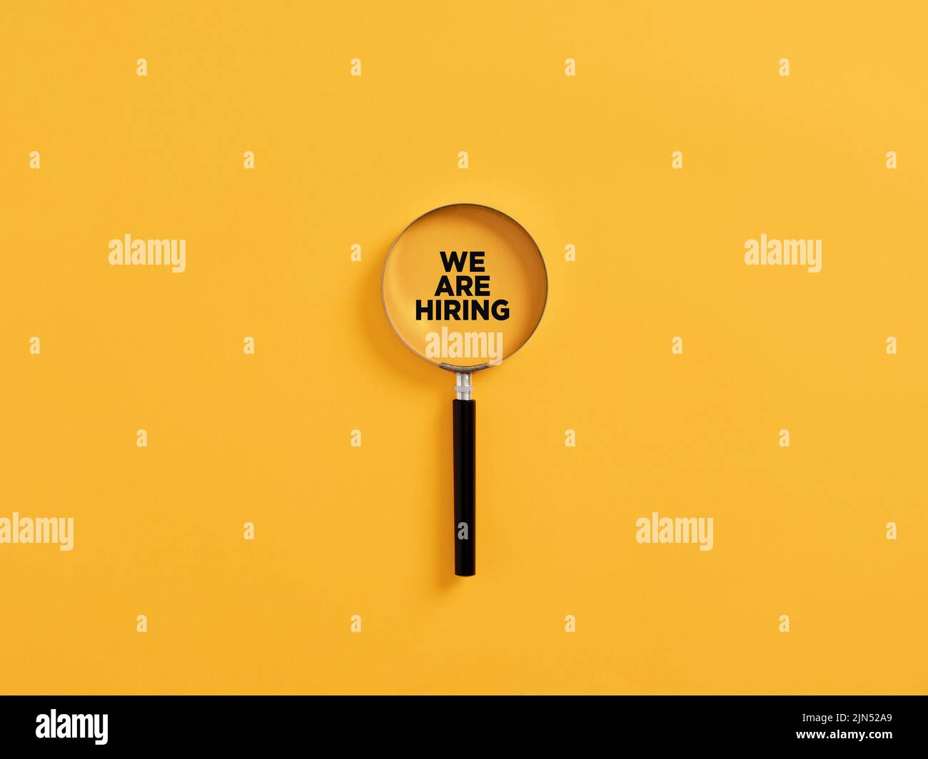 Magnifying glass or magnifier with the announcement we are hiring ...