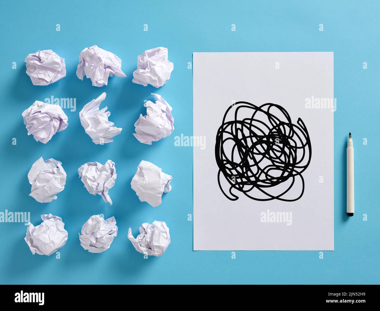 Hand drawn scribble icon on a paper sheet with crumpled paper balls and ...