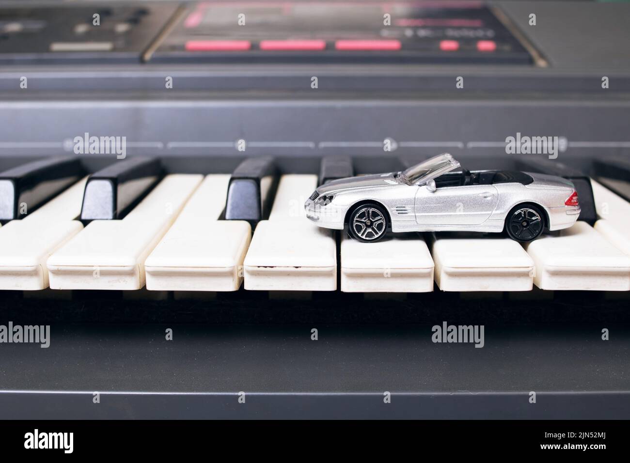 Gray toy car on piano keys close up Stock Photo - Alamy