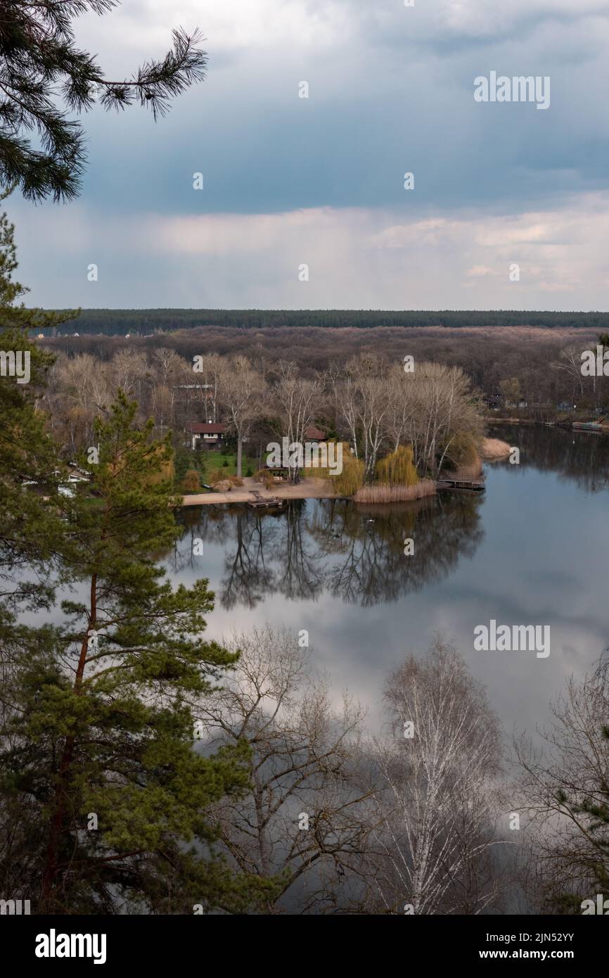 Spring rainy clouds on river bank recreation area. Cossack mountain ...