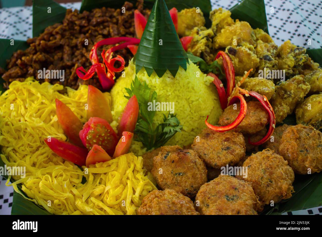 nasi kuning or yellow rice or tumeric rice is traditional food from ...