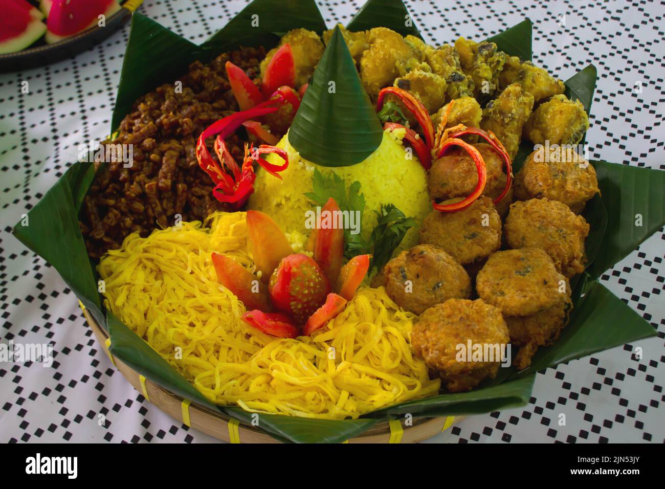 nasi kuning or yellow rice or tumeric rice is traditional food from ...