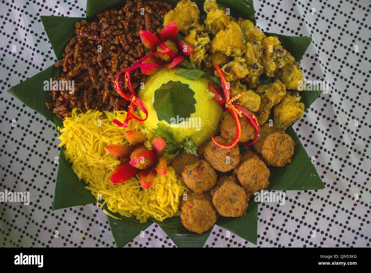 nasi kuning or yellow rice or tumeric rice is traditional food from ...