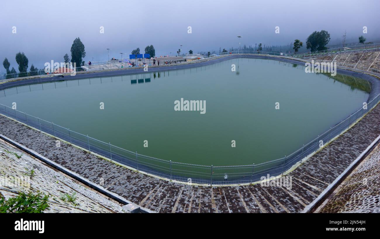 "Aerial view of a rainwater retention basin in morning with foggy ...