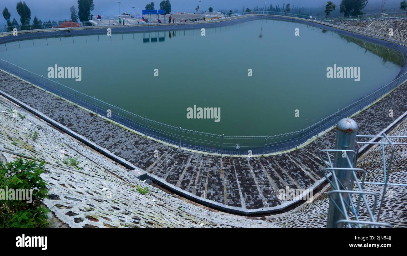 "Aerial view of a rainwater retention basin in morning with foggy ...