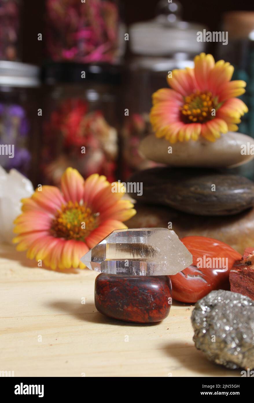 Quartz Crystal Balanced on Bloodstone With Flowers in Background Stock ...