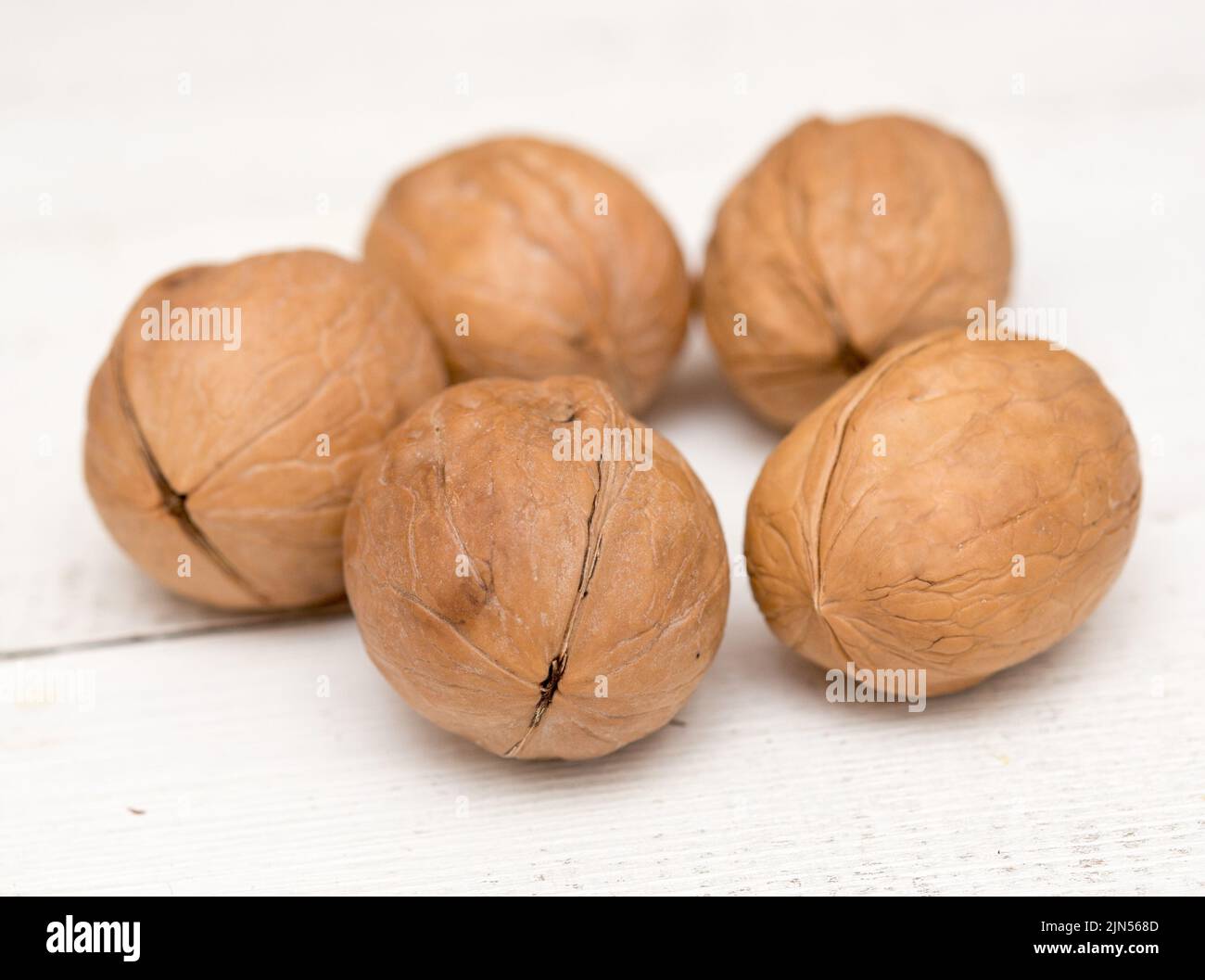 Walnuts on a wooden background Stock Photo - Alamy