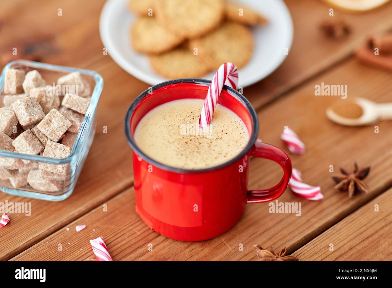 cup of eggnog with candy cane, cookies and sugar Stock Photo - Alamy