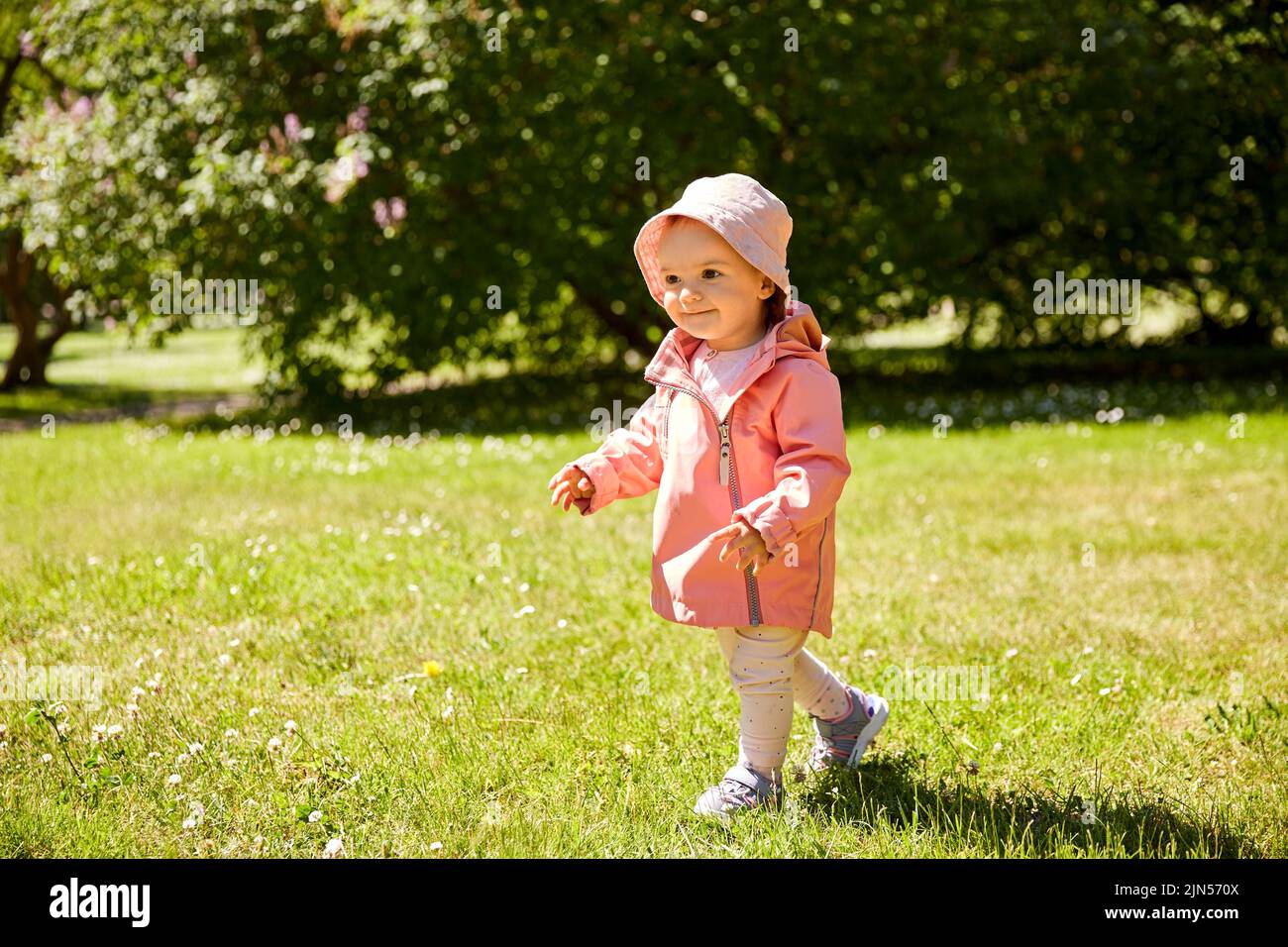 happy little baby girl walking at park in summer Stock Photo - Alamy
