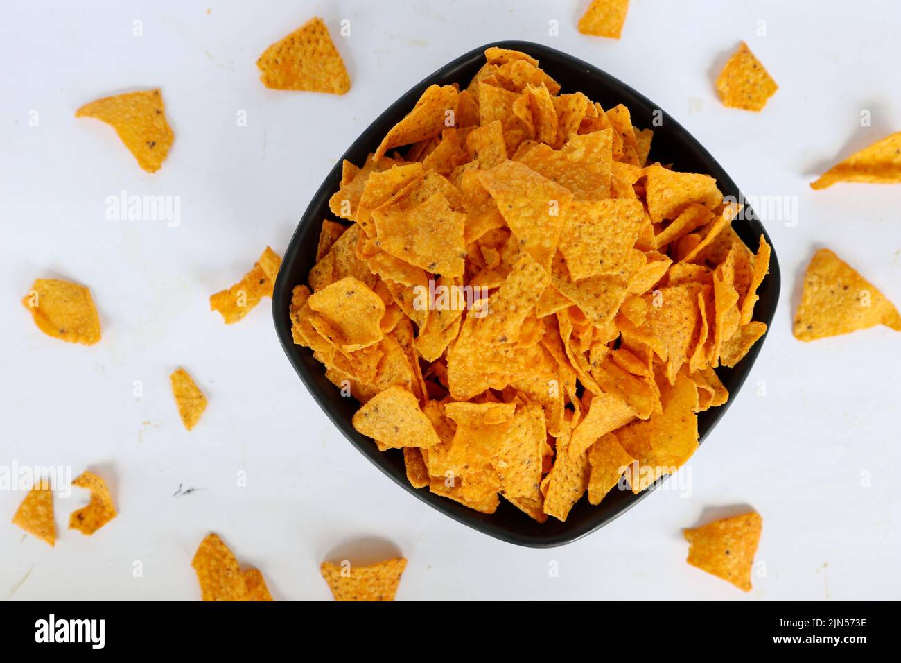 tortilla chip is corn chips or call nachos, served in bowl, on black ...