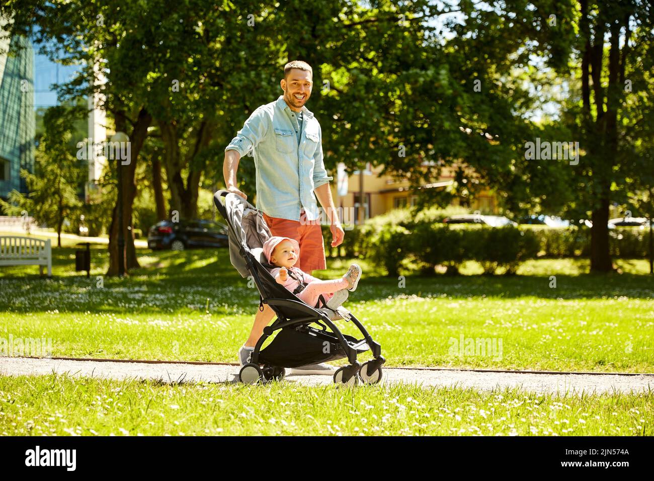 happy father with child in stroller at summer park Stock Photo - Alamy
