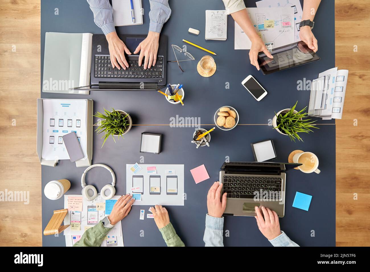 business team with gadgets working at office table Stock Photo - Alamy